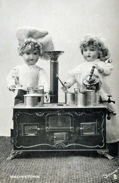 Dollys Kitchen two finely dressed porcelain dolls working